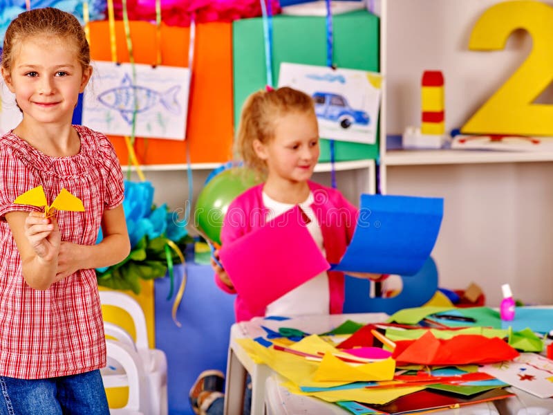 Kids Learning Do Origami by Colored Paper in Kindergarten . Stock Photo ...