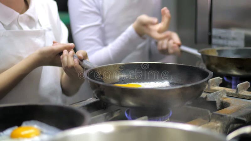 Kids Learning How To Cook Eggs in a Cooking Class in Restaurant Kitchen ...