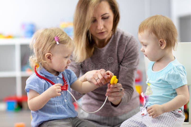 Kids Learning with a Teacher are a Doctor and Patient. Stock Image ...