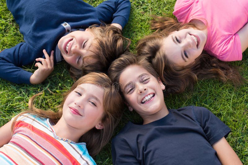 Kids lying on grass stock photo. Image of cute, childhood - 59776556