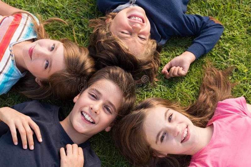 Kids lying on grass stock photo. Image of childhood, cheerful - 59780904