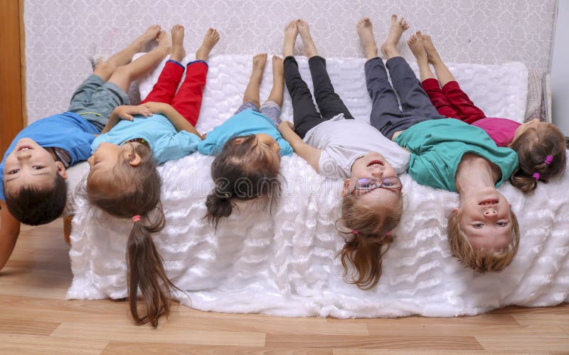 Kids are Lying on Their Backs on Sofa, Looking at Camera Stock Image ...