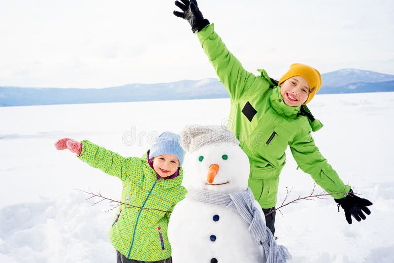 Kids making a snowman stock photo. Image of sister, snowman - 89171934