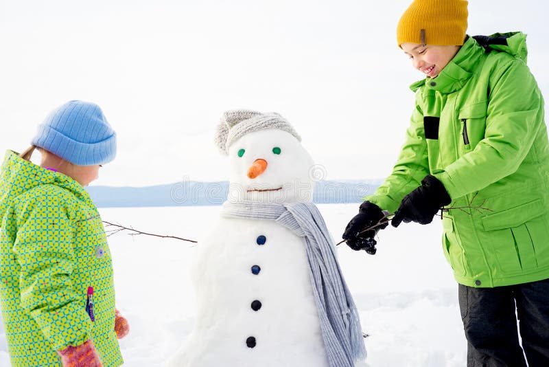 Kids making a snowman stock image. Image of frozen, beautiful - 89171935