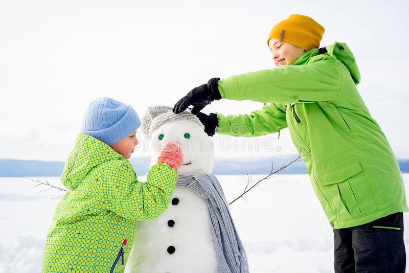 Kids making a snowman stock image. Image of cold, caucasian - 89171937
