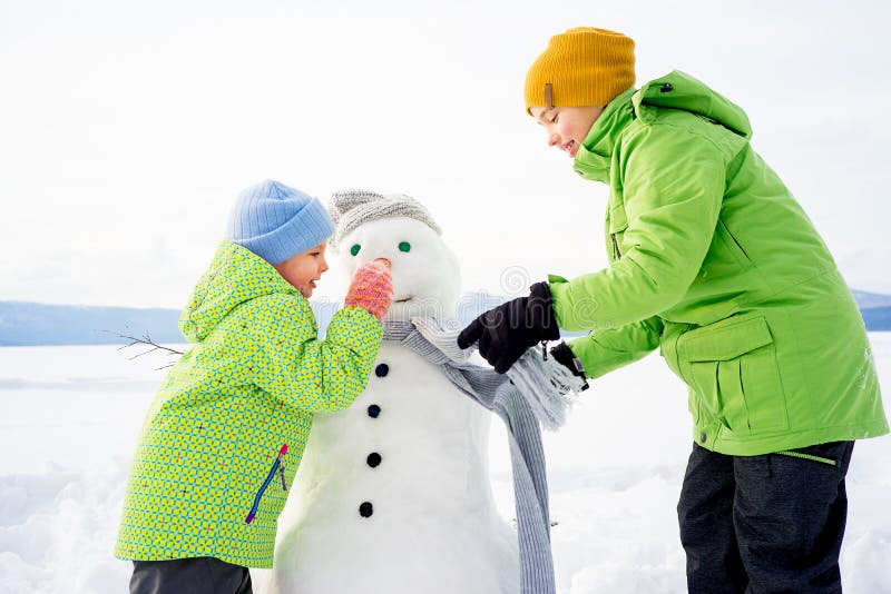 Kids making a snowman stock image. Image of people, snowballs - 89171967