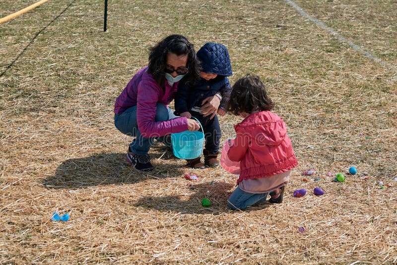 Kids with Mom are Searching for Easter Eggs during an Egg Hunt Stock Photo - Image of childhood ...