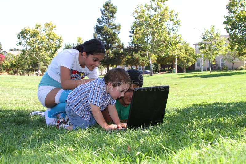 Kids in Park with Computer stock image. Image of laptop - 15730601