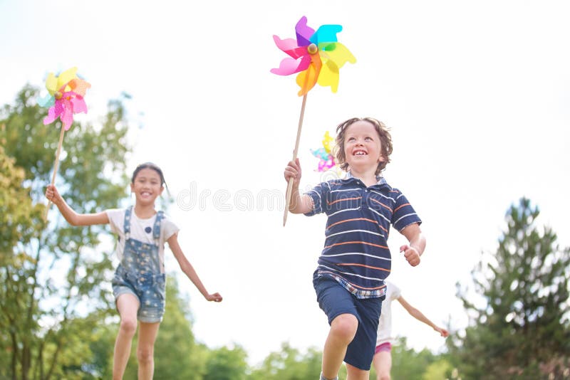 Kids with pinwheels stock image. Image of childhood, child - 70257731