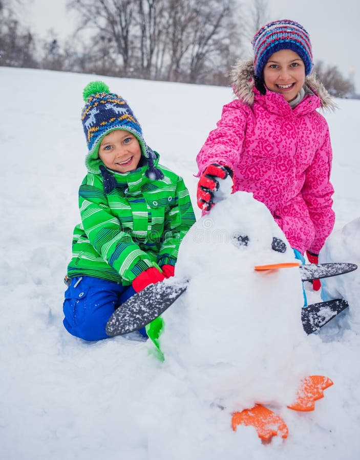 Kids plaing in the snow stock photo. Image of cheerful - 63475148