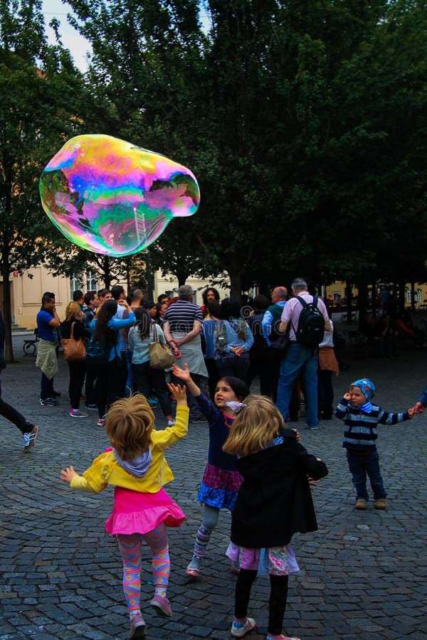 Kids play a bubbles editorial stock image. Image of enjoy - 65594589