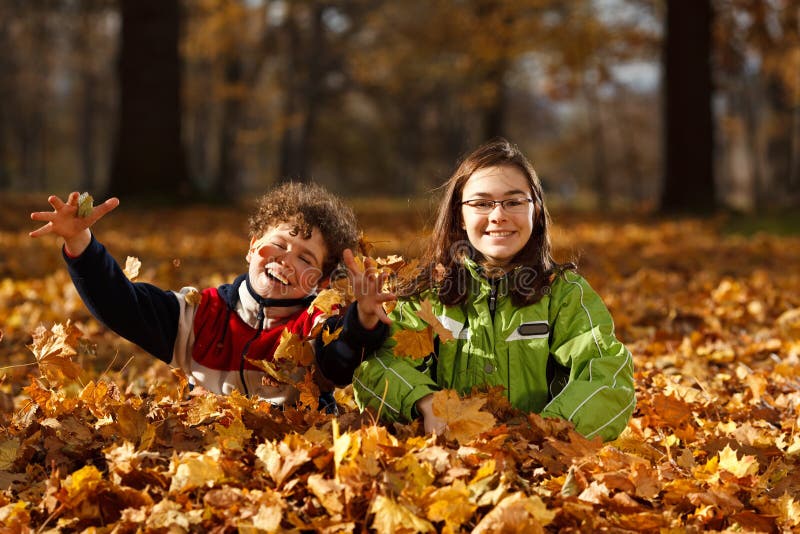 Kids Playing in Autumn Park Stock Photo - Image of autumn, play: 23097280