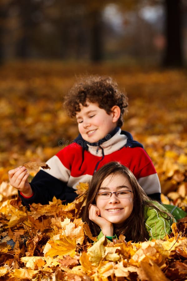 Kids in autumn leaves stock photo. Image of orange, male - 11837308