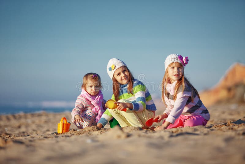Kids playing at the beach stock photo. Image of playing - 16915018