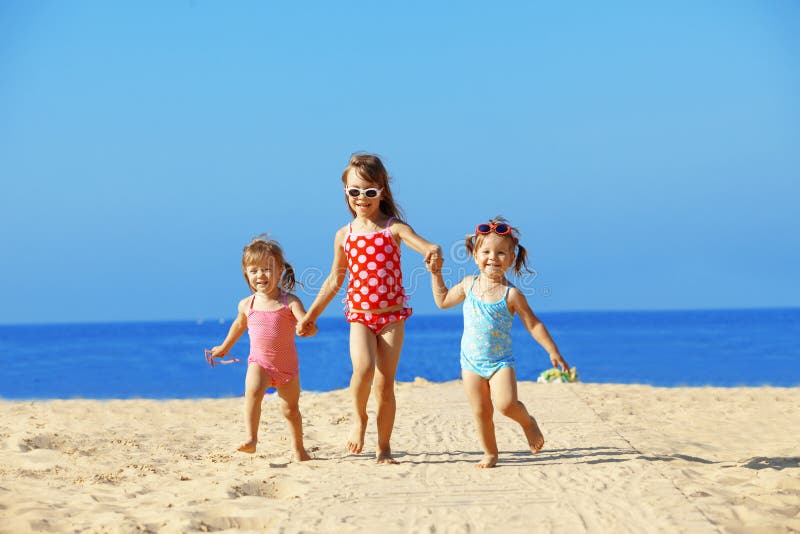 Kids playing at the beach stock photo. Image of lifestyle - 20461598