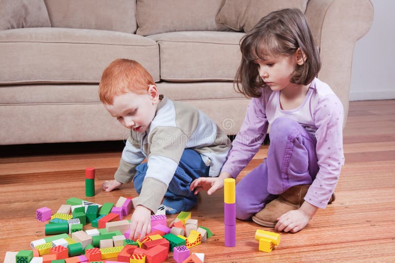 Kids playing with blocks stock image. Image of floorboards - 15793237