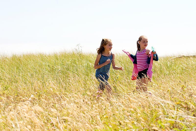 Kids Playing in a Field of Tall Grass Stock Image - Image of playing ...