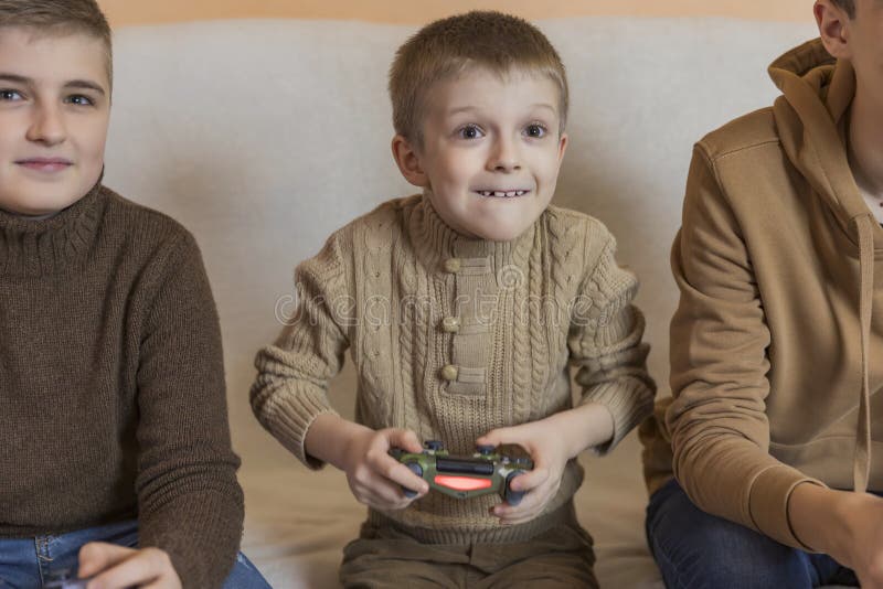Kids playing games stock image. Image of console, sitting - 245336227