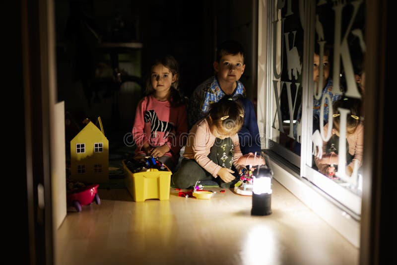 Kids Playing at Home during a Blackout Using Lantern Stock Image ...