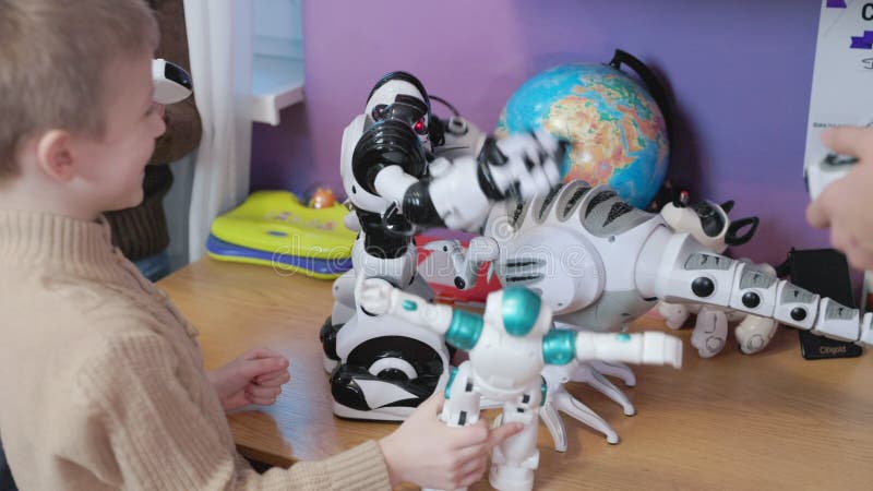 Kids playing with robots stock footage. Video of mechanical - 241860796