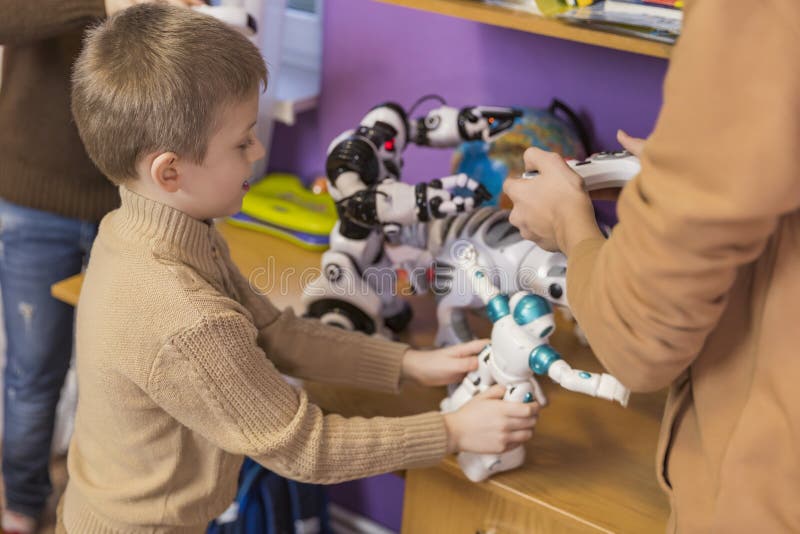 Kids playing with robots stock photo. Image of block - 242275016