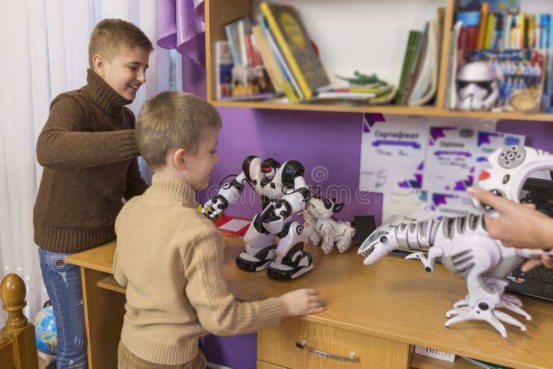 Kids playing with robots stock photo. Image of development - 242426626