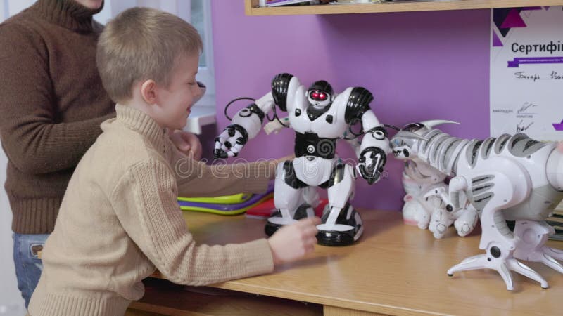 Kids playing with robots stock video. Video of machine - 242856741