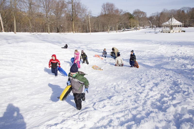 Kids playing in snow editorial stock photo. Image of ride - 26126873