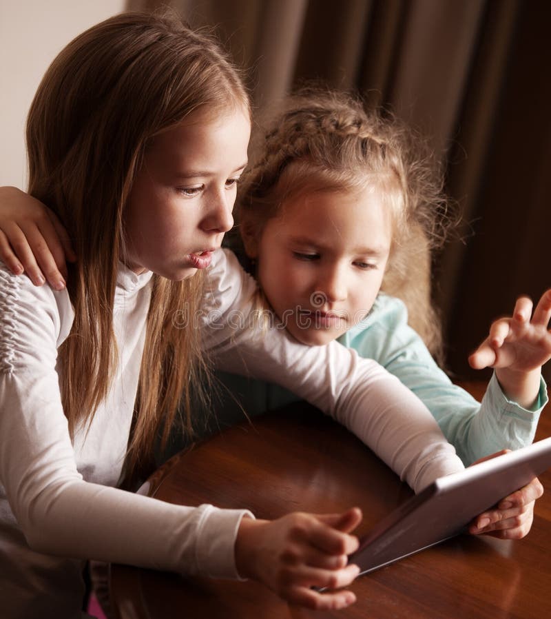Kids playing on tablet stock image. Image of looking - 37116937
