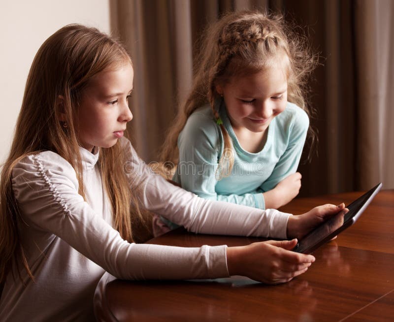 Kids playing on tablet stock image. Image of looking - 78950053