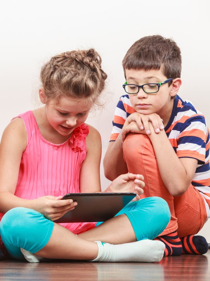Kids playing on tablet. stock photo. Image of communication - 66109160