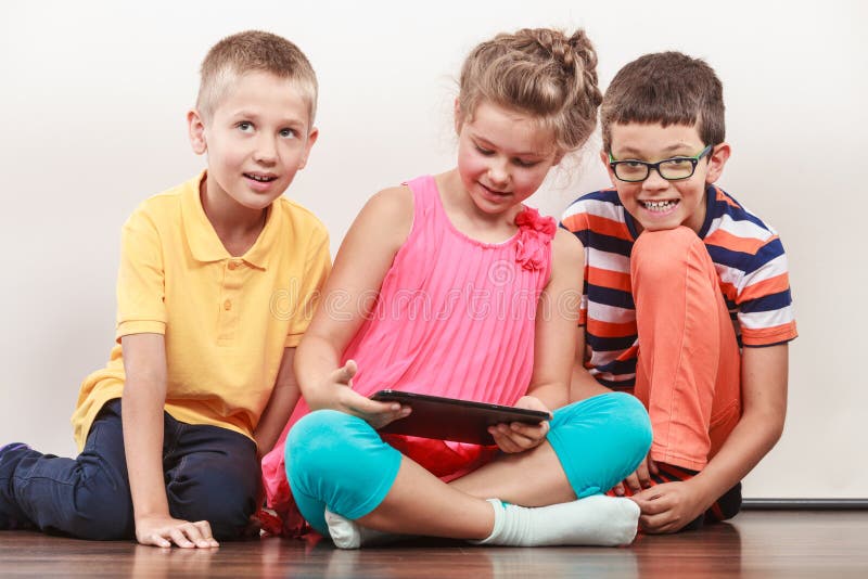Kids playing on tablet. stock image. Image of friendship - 76156889