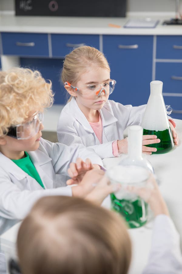 Kids in Protective Glasses and Lab Coats Making Experiment Stock Image ...