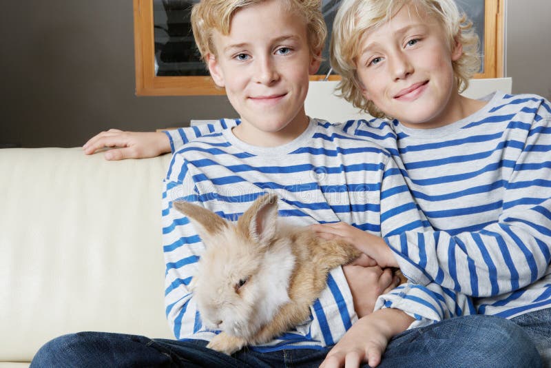 Kids with Rabbit at Home stock photo. Image of couch - 28833594