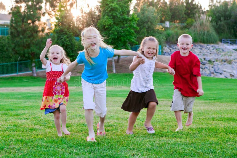 Kids running on the grass stock photo. Image of smiling - 10103830