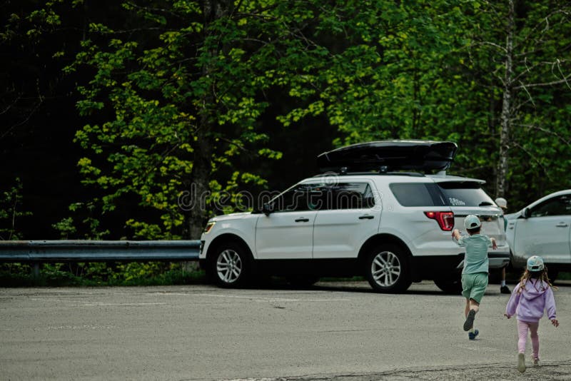 Kids Running To Car in Parking at Austrian Alps Stock Photo - Image of ...