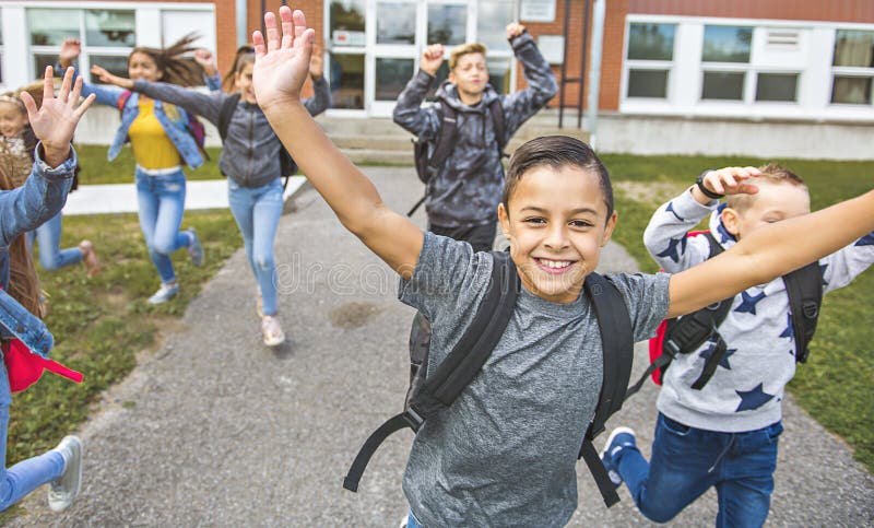 Group of Kids on the School Background Having Fun at the End of Class ...