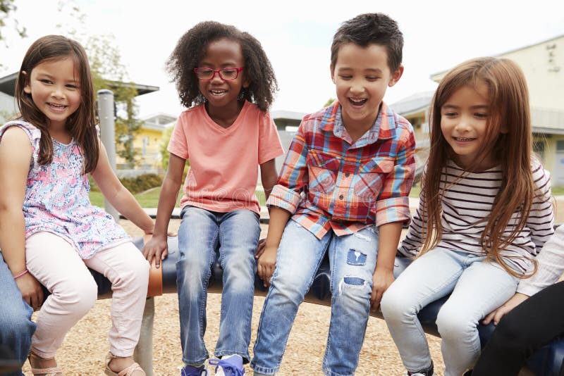 Kids Sitting On A Spinning Carousel In Their Schoolyard Stock Image ...