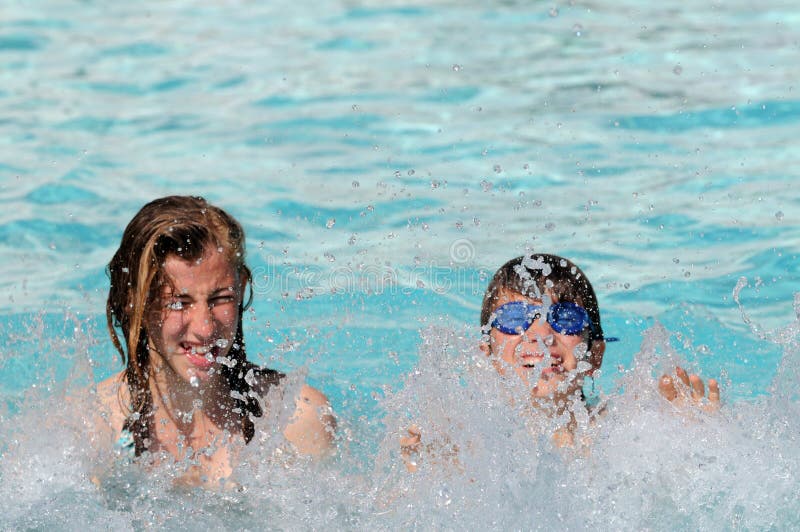 Little Children Splashing In The Swimming Pool Stock