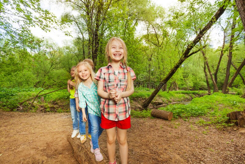 Kids Standing on a Log One after Another in Forest Stock Image - Image ...