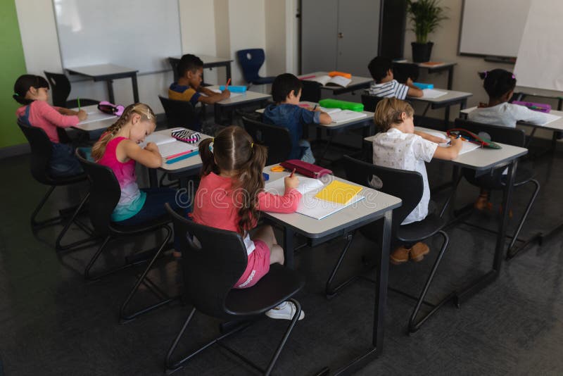 Kids studying in classroom stock image. Image of drawing - 137887179