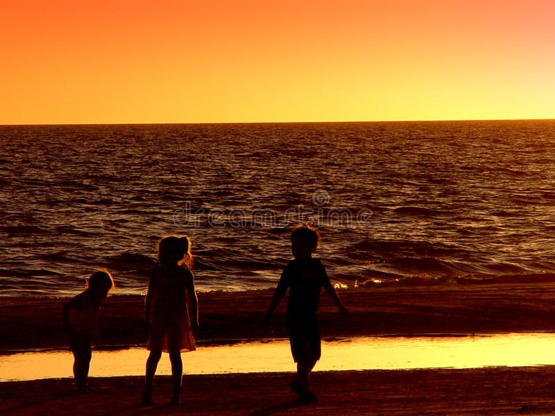 Kids at sunset stock photo. Image of dusk, kids, beach - 1376204