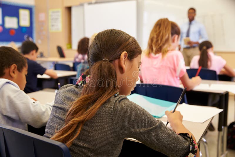Kids Taking Notes in an Elementary School Lesson Stock Photo - Image of ...