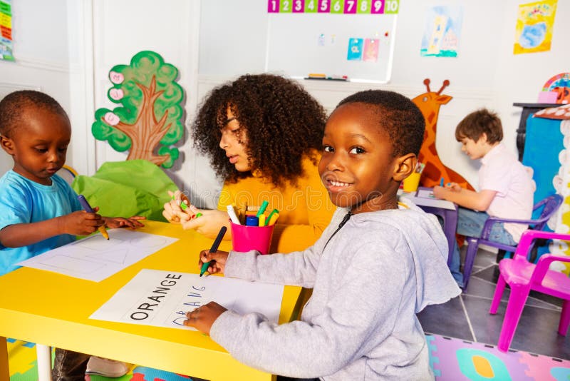 Kids with Teacher Learn To Write Words by a Model Stock Image - Image ...