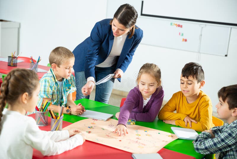 Kids with Teacher Playing Educational Tabletop Game Stock Photo - Image ... Kids with Teacher Playing Educational Tabletop Game Stock Photo - Image ...