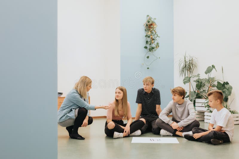 Kids and Teacher Sitting on the Working on the Project Together Stock ...