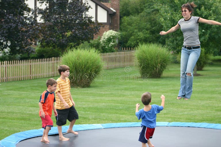 Kids on Trampoline stock photo. Image of grass, jumping - 1244528