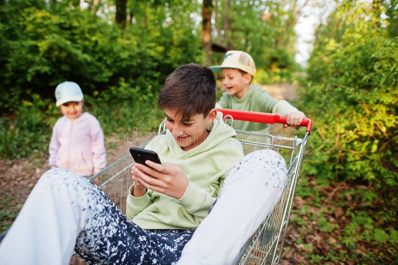 Kids with Trolley Having Fun in Forest Stock Photo - Image of childhood ...