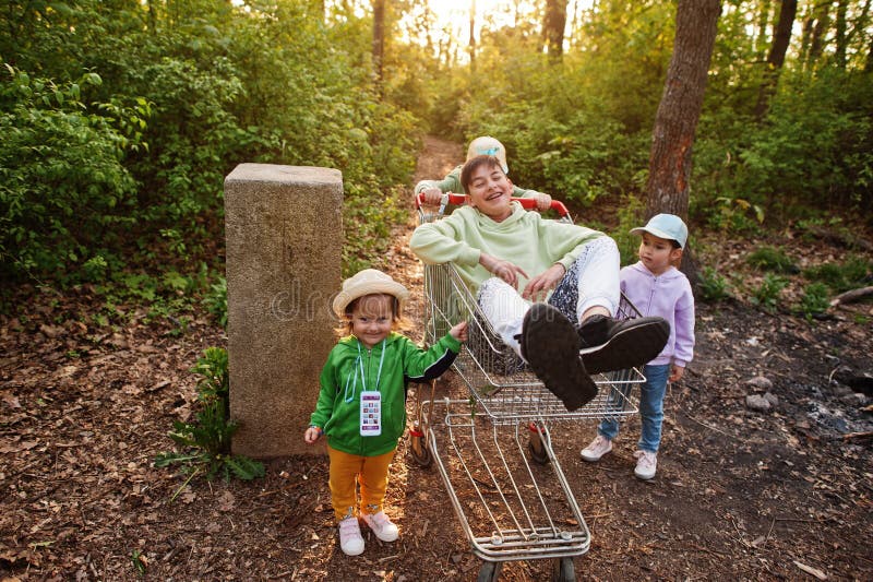 Kids with Trolley Having Fun in Forest Stock Photo - Image of buyer ...
