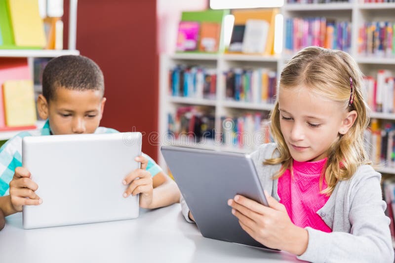 Kids Using Digital Tablet in Library Stock Photo - Image of innocence ...